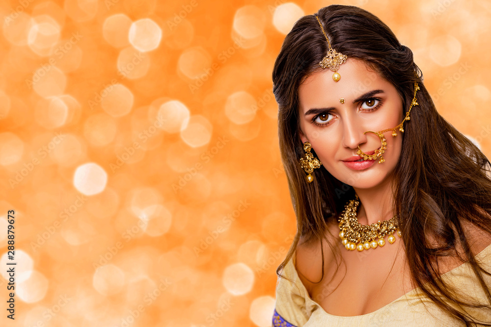 Portrait of beautiful indian girl. beauty portrait. isolated. orange ...