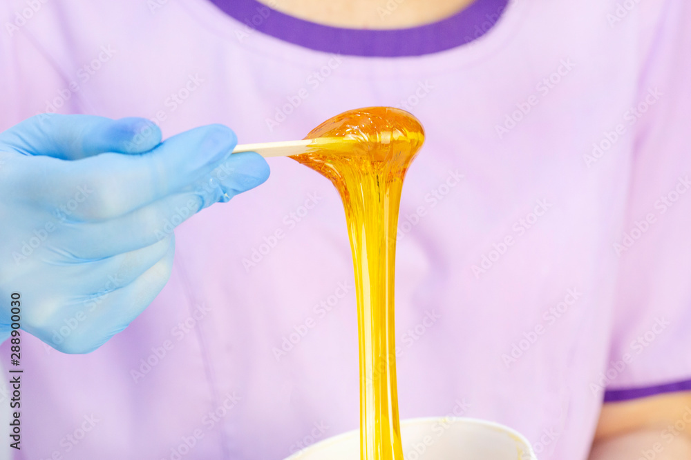 Liquid sugar for skin epilation. Close up shot. depilation and beauty ...