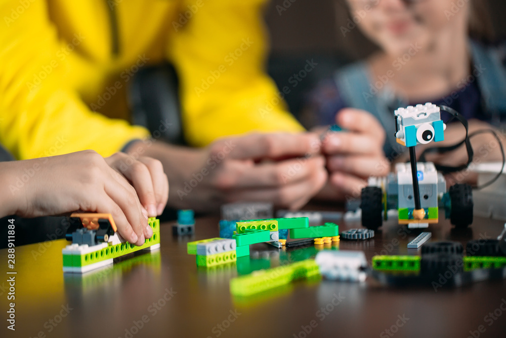 Kids creating robots with teacher. Early development, diy, innovation ...
