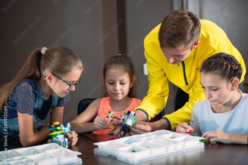 Kids creating robots with teacher. Early development, diy, innovation ...