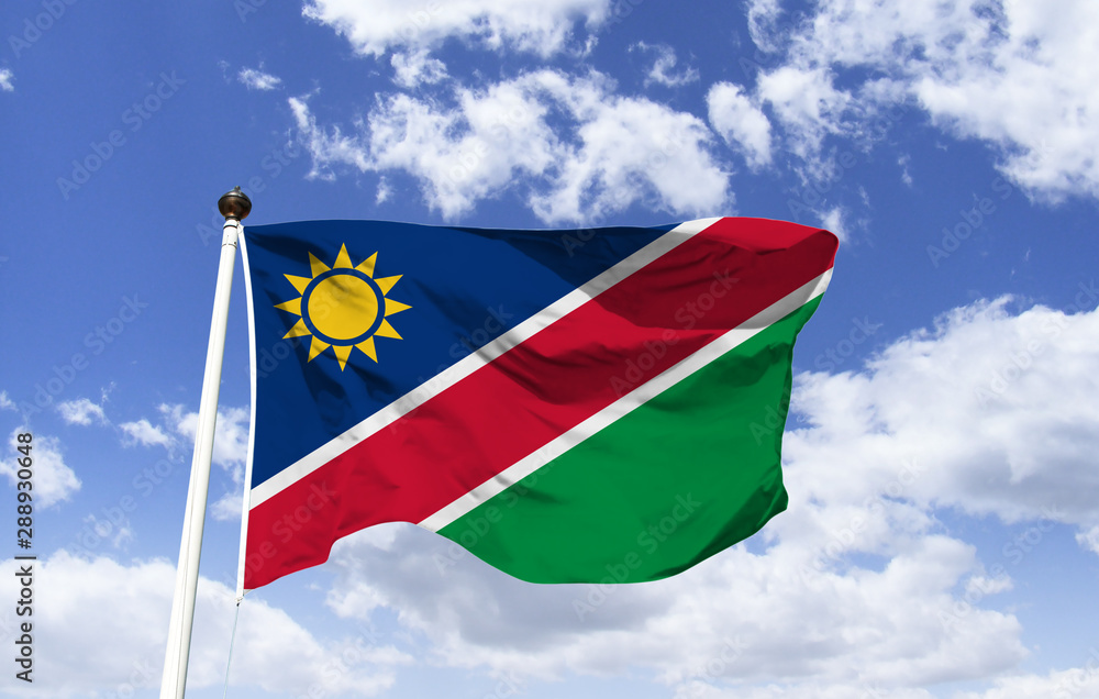 Model of Namibian flag fluttering under a blue sky. Country Southwest ...