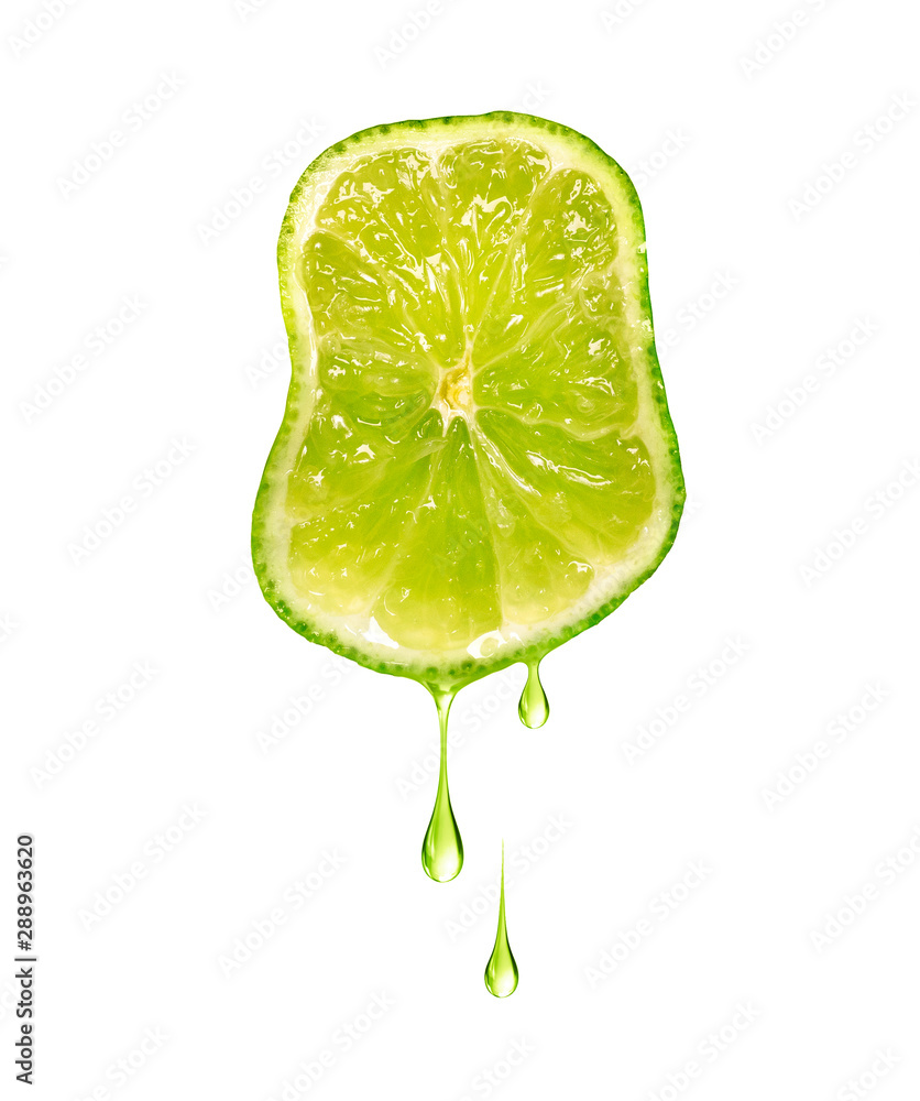 Drops of juice dripping from sliced lime isolated on a white background ...