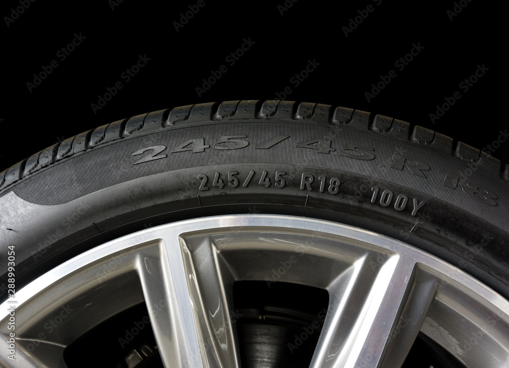 Close up of Number code on sidewall of car tyre with alloy wheel, Tyre Sidewall Markings. Stock ...