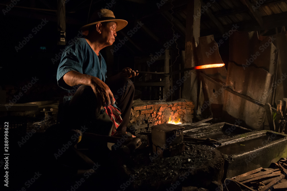Professional Blacksmith at work is Hit the iron by a hot metal With ...