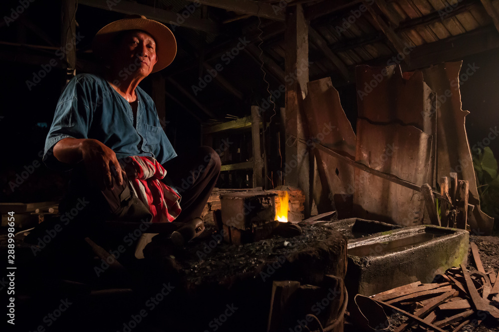 Professional Blacksmith at work is Hit the iron by a hot metal With ...