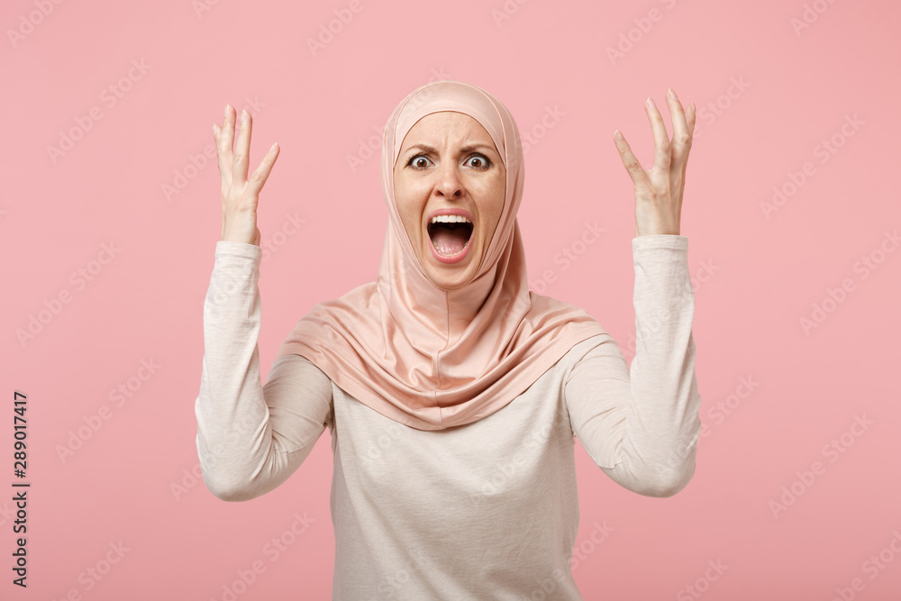 Shocked irritated arabian muslim woman in hijab light clothes posing ...