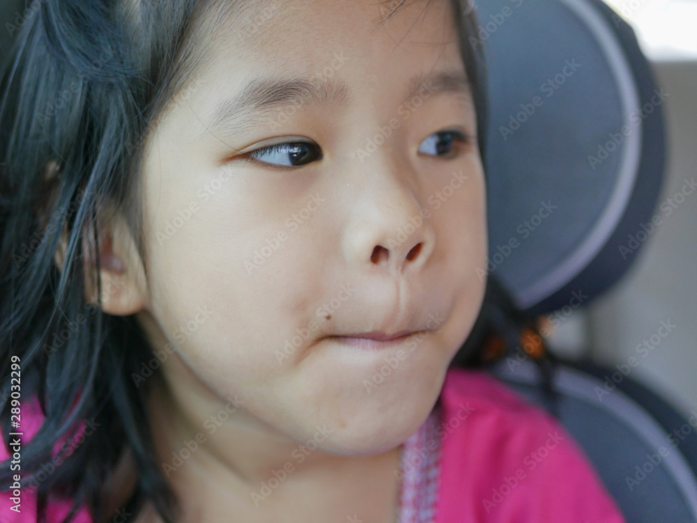 Little baby girl pursing her lips, as she was pondering her thought on ...