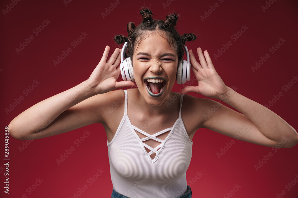 Image of excited punk girl with bizarre hairstyle screaming at camera ...