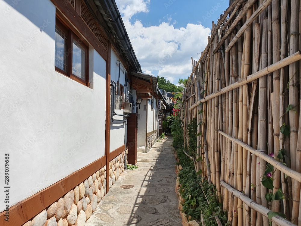 Asian, Korean style house with bamboo fence and beautiful blue sky ...