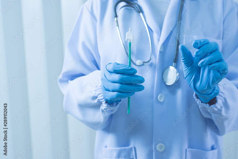 Doctor hand holding liquid base cytology set on blue background ...