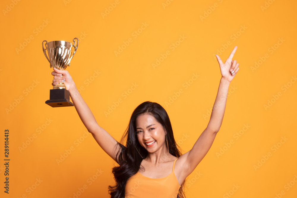 Successful number one winner young asian woman holding a trophy. Stock ...