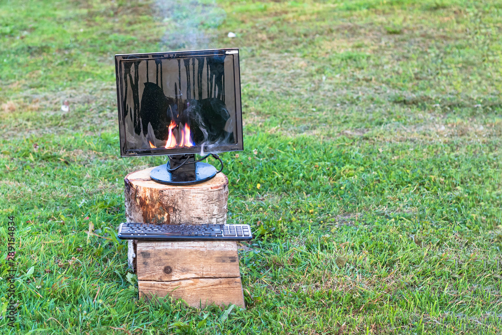 computer, monitor on fire. there is a keyboard. concept time to update ...