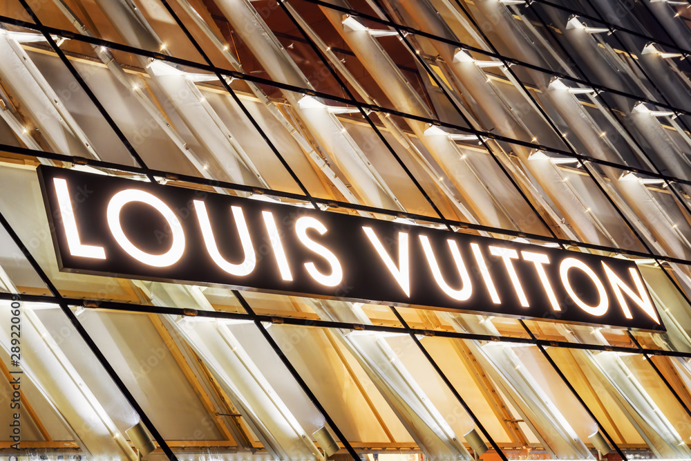 Glowing logo of Louis Vuitton store by Marina Bay, Singapore Stock ...