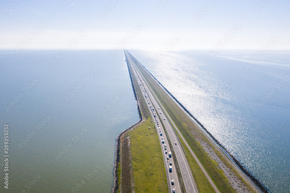 Afsluitdijk, a major dam and causeway in the Netherlands, runs from Den Oever in North Holland ...