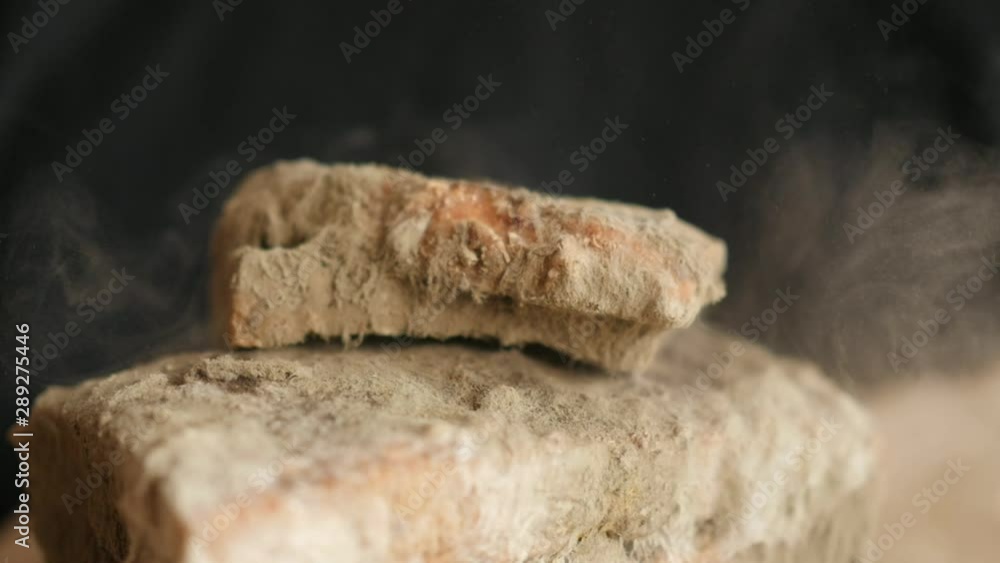 slice of bread falling on moldy bread, particles of mold slow motion ...