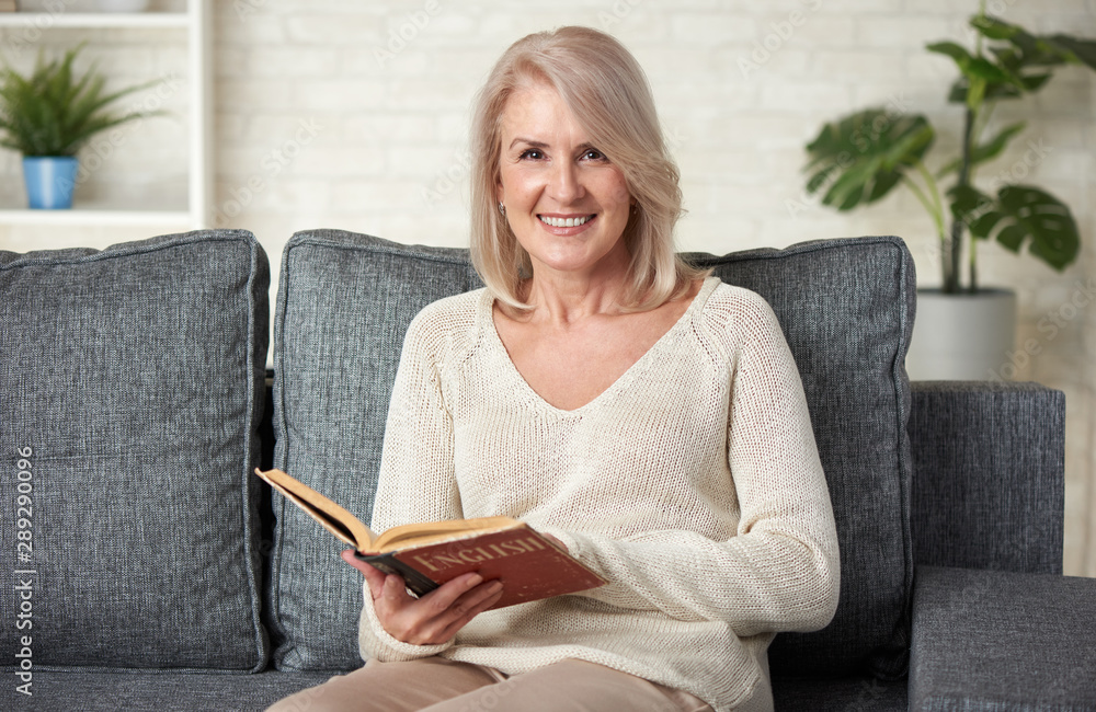 Beautiful 50 years old woman reading an english textbook Stock Photo ...