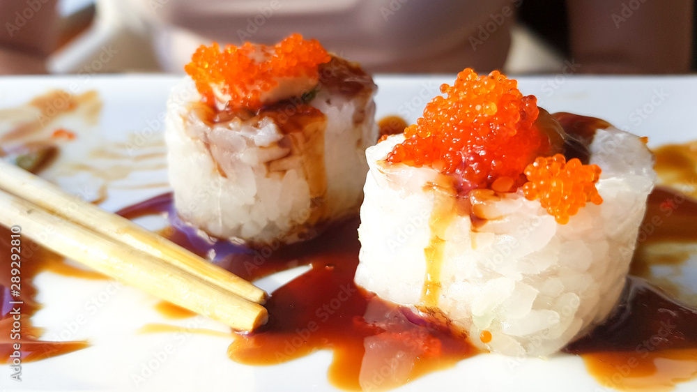Stylish roll with tempura shrimp in a hot unagi sauce. sushi rolls with ...