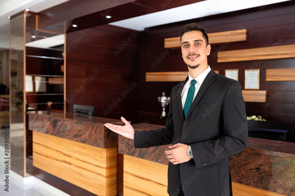 Polite receptionist welcoming hotel guests Stock Photo | Adobe Stock