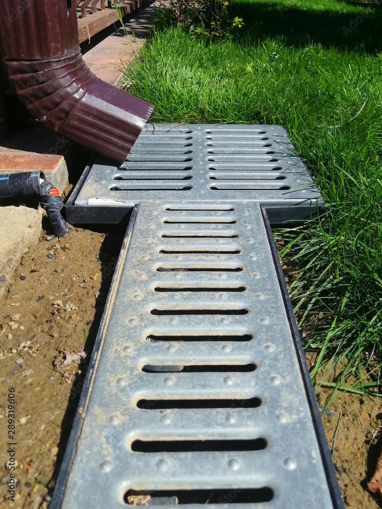 Drainage systems. Metal structure rainwater. Sewerage and grate on the ...