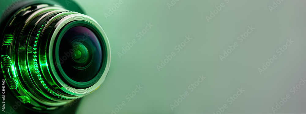 Banner. The camera lens and light green. Side view of the lens of ...