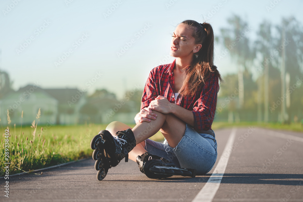 Woman injured knee while rollerblading. A teenager having a bruise ...