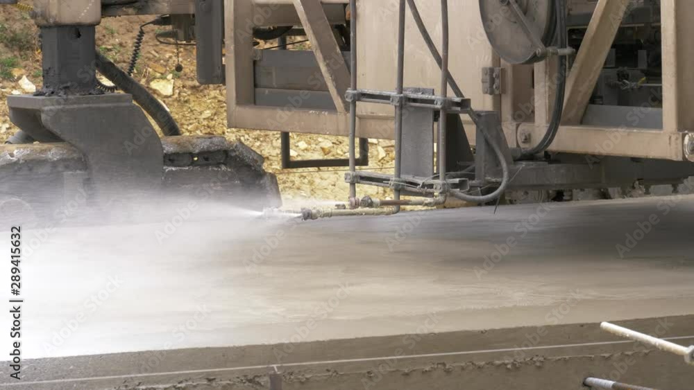 Fully mechanised construction of concrete road. Spraying speciality ...