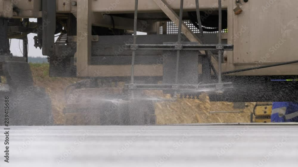 Fully mechanised construction of concrete road. Spraying speciality ...