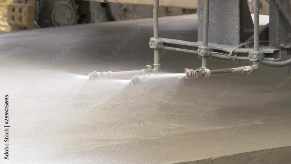 Fully mechanised construction of concrete road. Spraying speciality ...