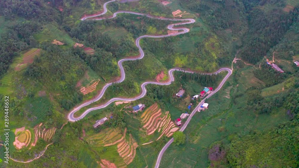 A winding wiggling road cut beautifully into the mountainside on the ...