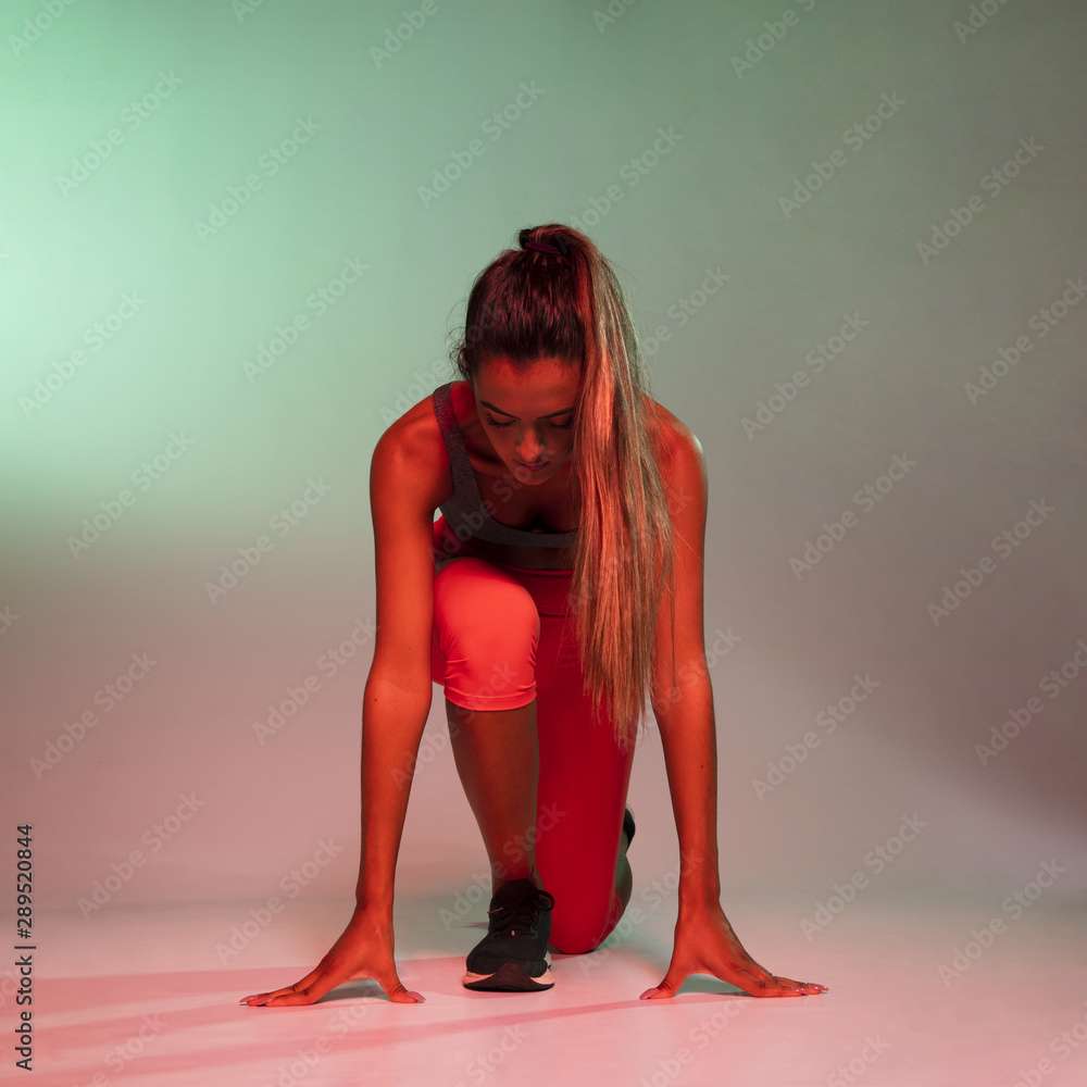 Front View Of Woman In Crouch Starting Position - Stock - GamesAgeddon