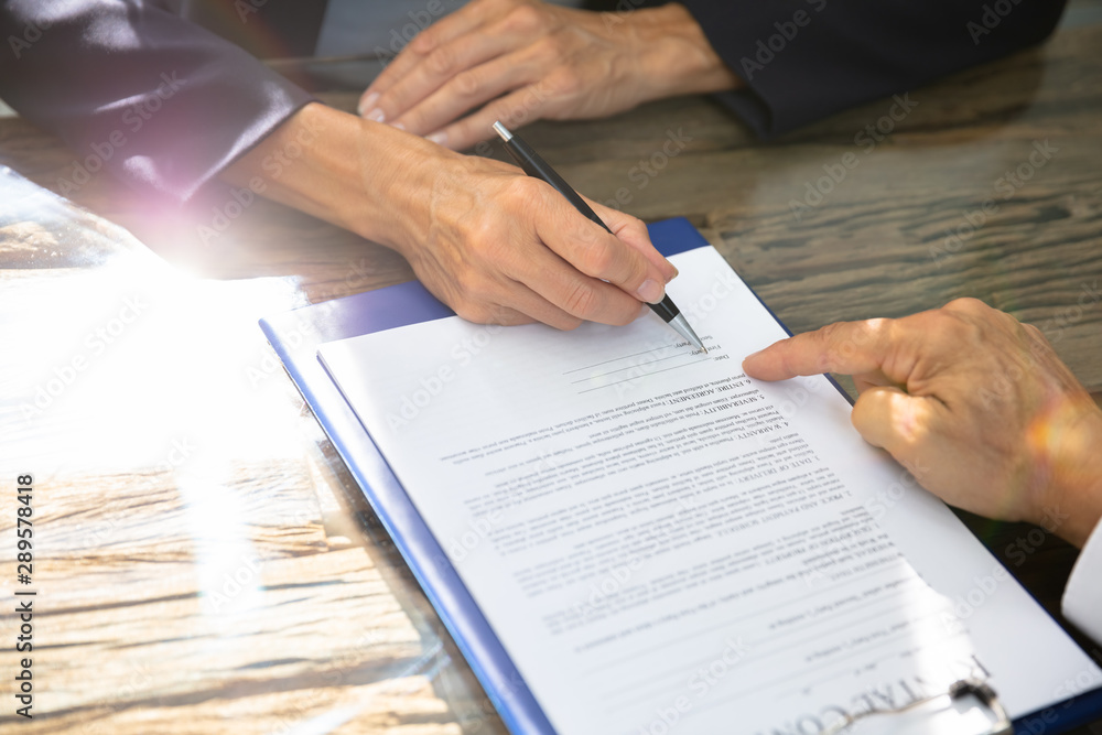Close-up Of A Person's Hand Filling Contract Form Stock Photo | Adobe Stock