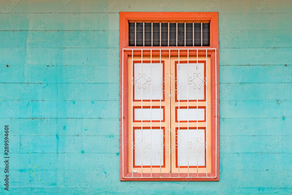 Window with turquoise wooden wall in the city center of Guayaquil ...