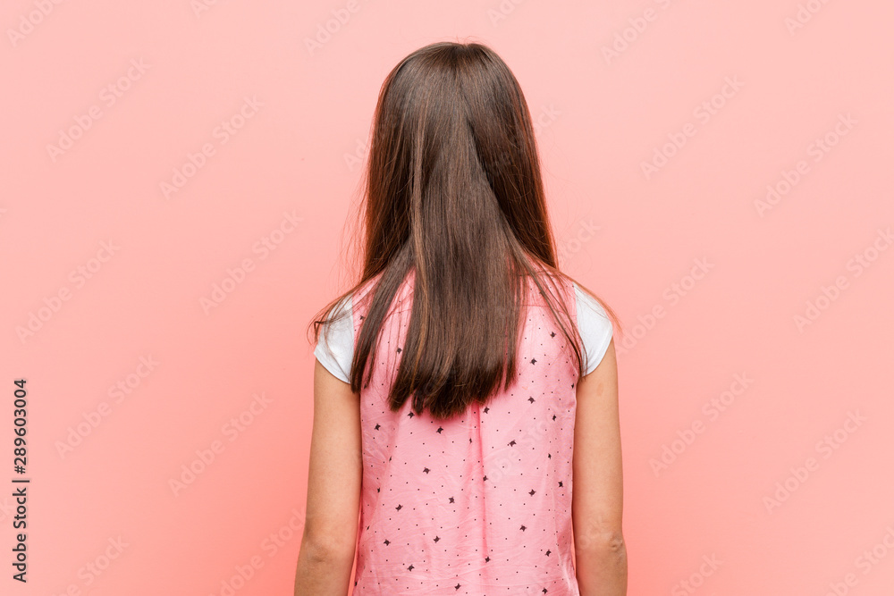 Cute little girl from behind, looking back. Stock Photo | Adobe Stock