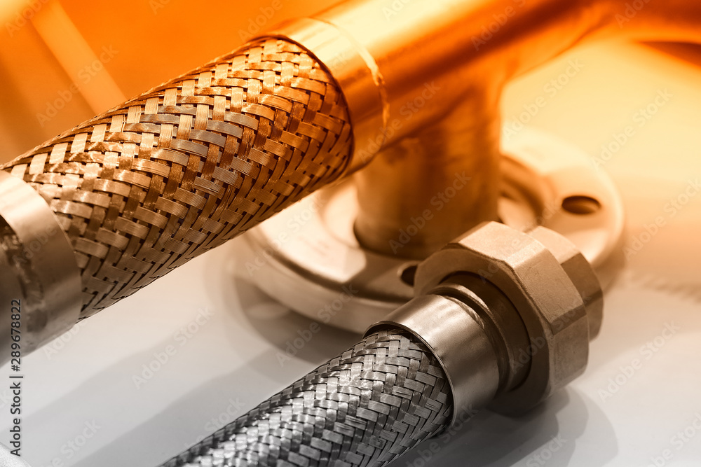 Metal flexible tube, adapter, connecting nut. Plumbing equipment. Red ...