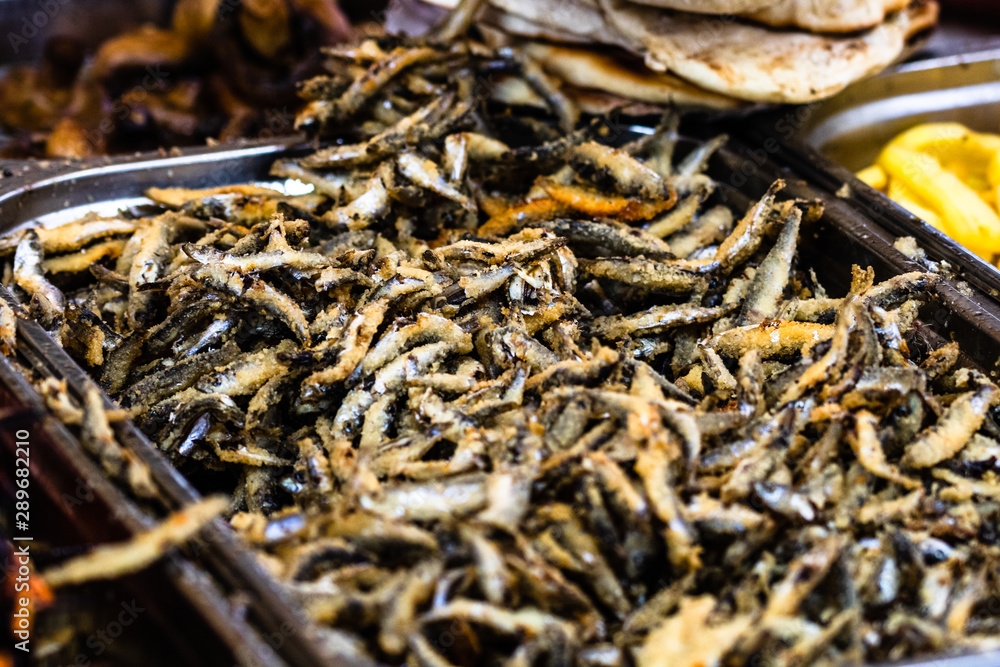 Fried little fish in market or food festival, food truck, food market ...