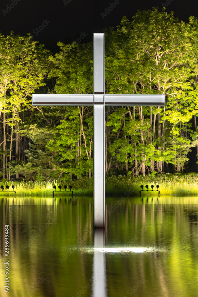 Cross on the water with an inverted reflection in a beautiful nature ...