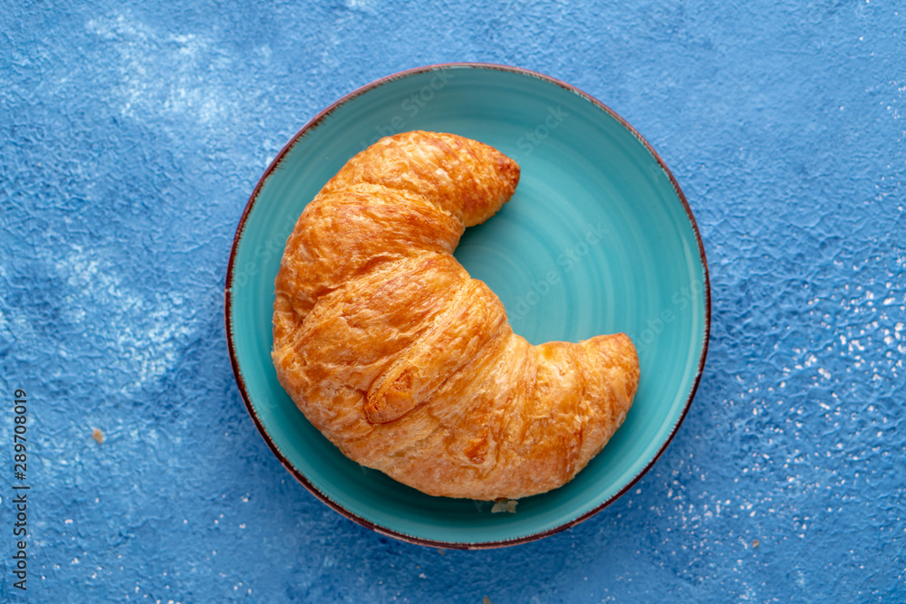 Flacky crispy fresh croissant rolls with blue background Stock Photo ...