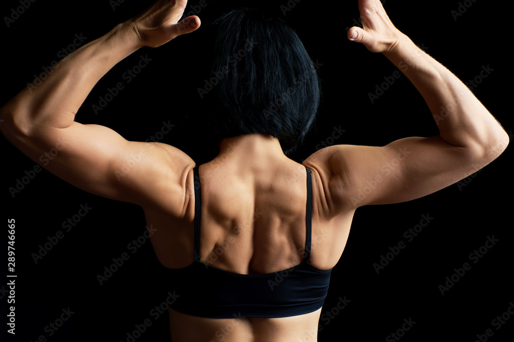 young athletic girl with black hair turned her back and showing a ...