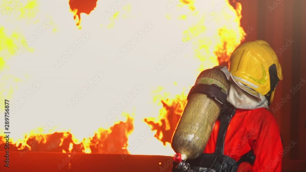 HD Slow motion medium shot of firefighter in fire suit on safety rescue ...