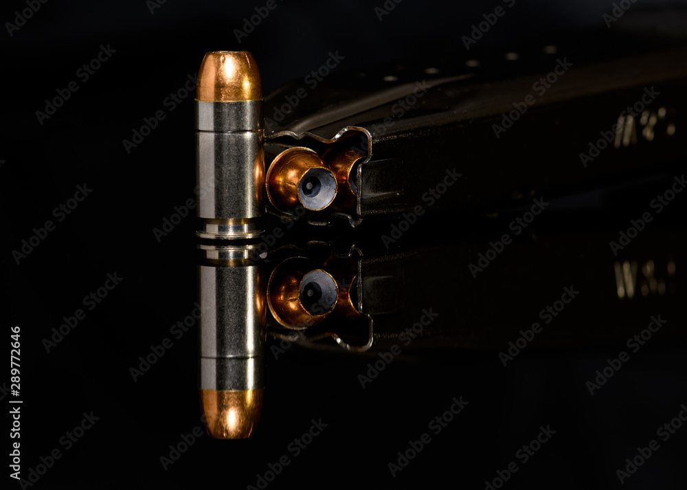 40 Caliber ammunition with magazine on black background Stock Photo ...