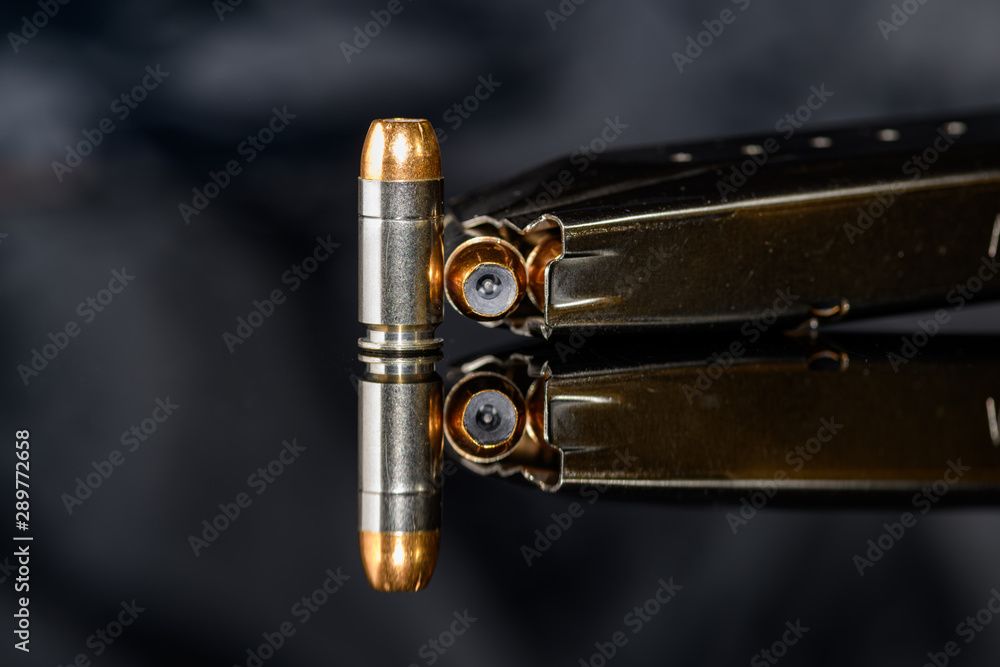 Foto de 40 Caliber ammunition with magazine on black background do ...