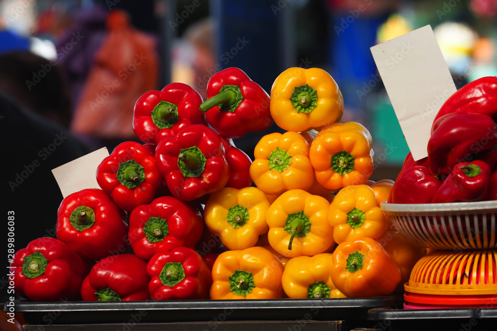 Vegetable market, a pyramid of juicy Bulgarian sweet red and yellow ...