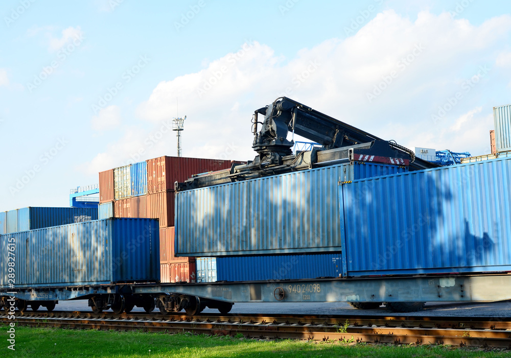 Shipping container loading by richtracker on the freight rail car at ...