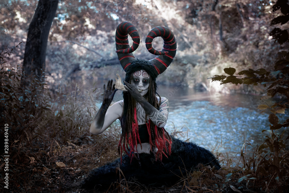 Fairytale photo with demonic horned faun playing on the jawbone of an ...