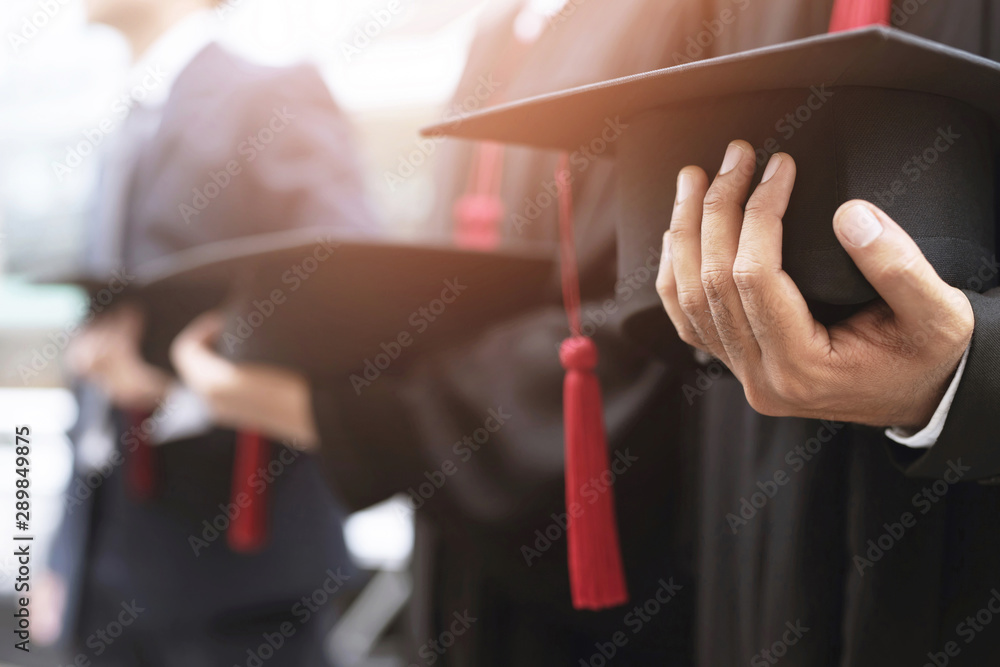 graduation,Student hold hats in hand during commencement success ...