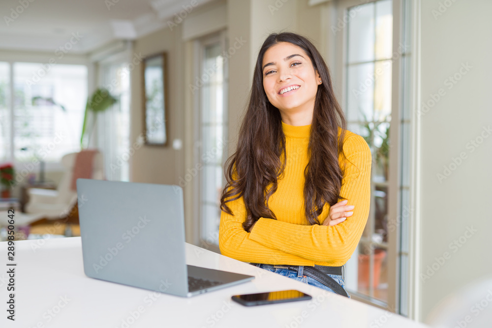 Young woman using computer laptop happy face smiling with crossed arms ...