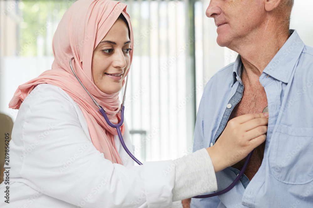 Portrait of young Arab woman working as doctor in medical clinic and ...