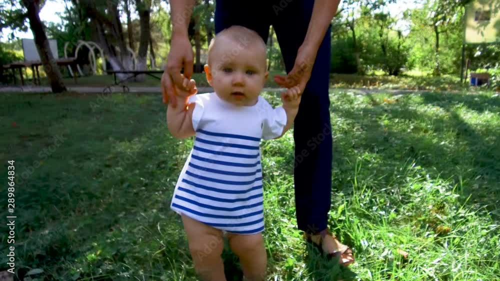 Little baby learns to walk. First Steps. Parents are teaching their ...