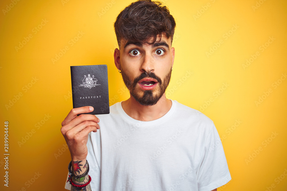 Young man with tattoo wearing Australia Australian passport over ...