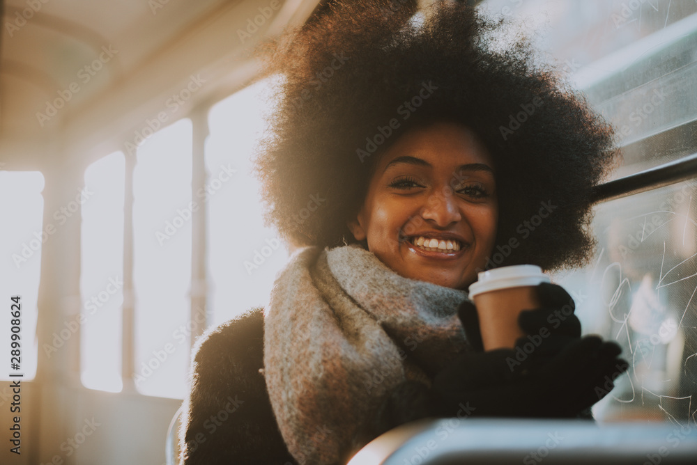Beautiful girl with afro haircut portraits in the public transport ...